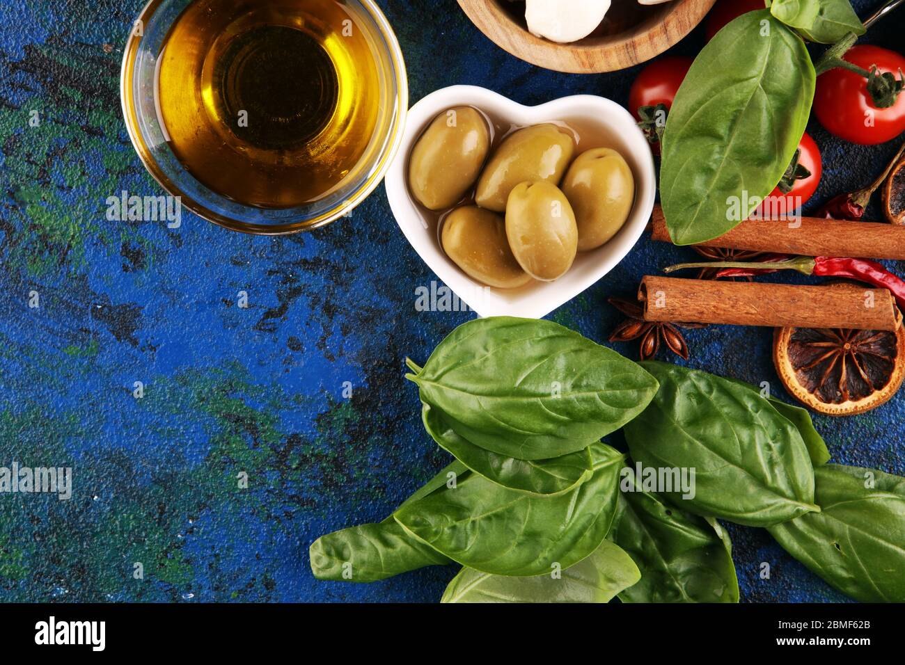 Italian food background with herbs and spices, vine tomatoes, basil ...