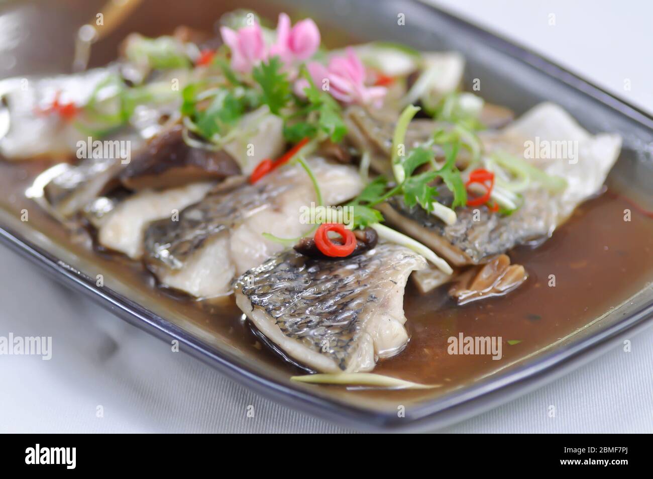steamed fish, steamed striped bass or stewed bass fish Stock Photo - Alamy