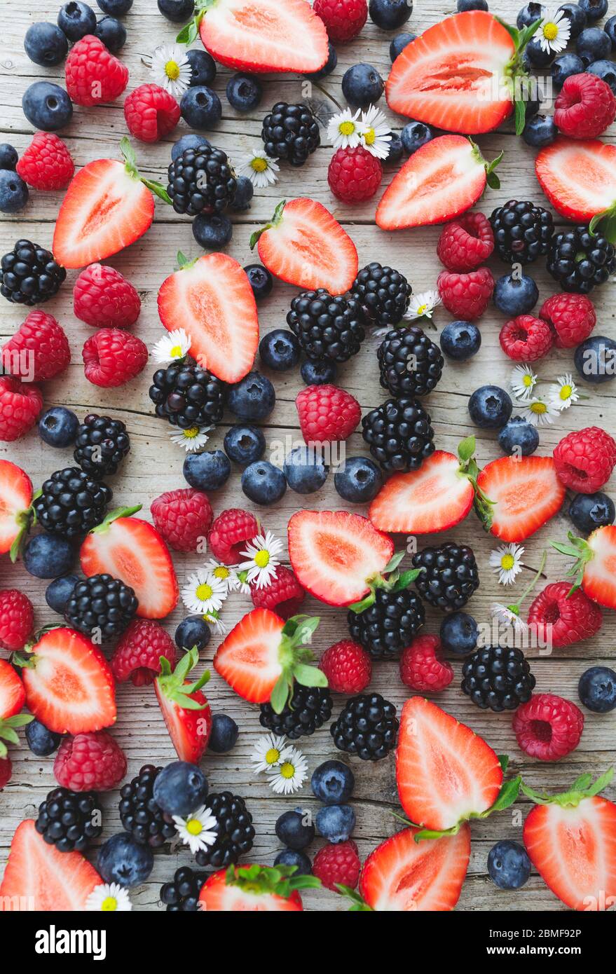 different kinds of fresh berries on background photo taken from above ...