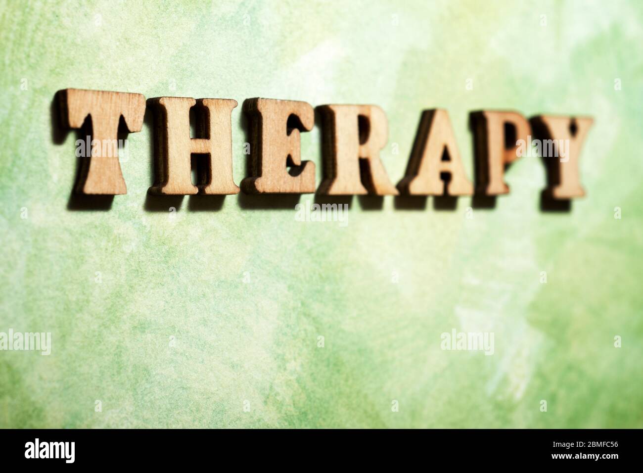 Therapy word on a green paper Stock Photo - Alamy