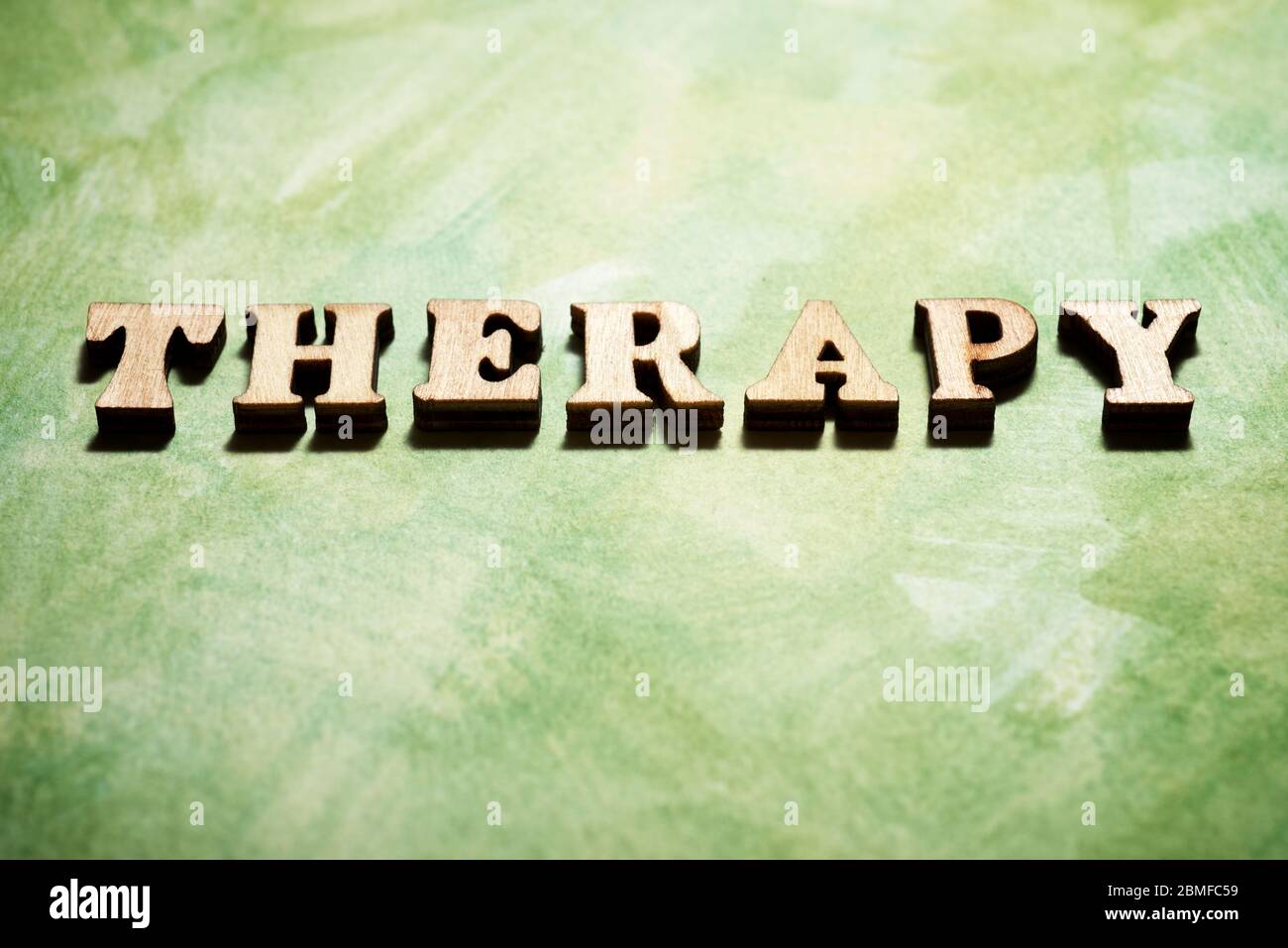 Therapy word on a green paper Stock Photo - Alamy