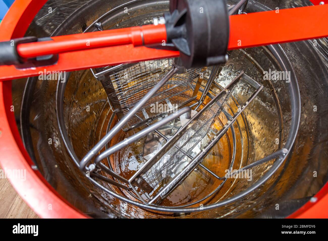 The process of extracting honey from bee honeycombs Stock Photo - Alamy