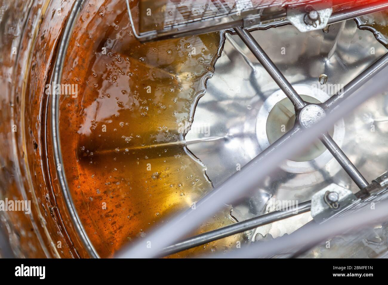 The process of extracting honey from bee honeycombs Stock Photo - Alamy