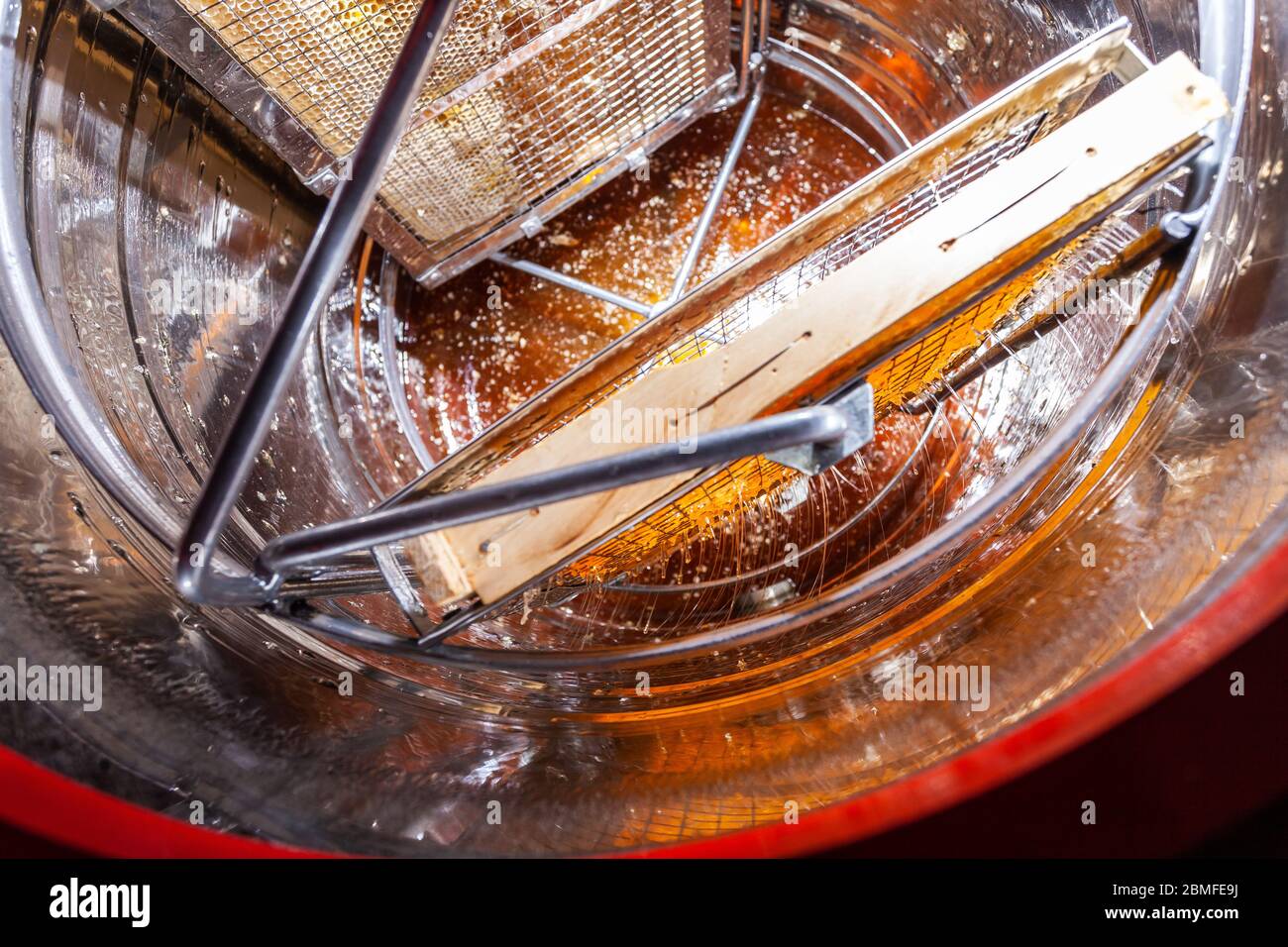 The process of extracting honey from bee honeycombs Stock Photo - Alamy