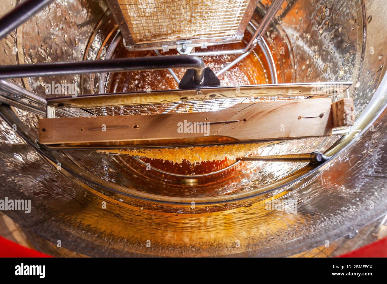 The process of extracting honey from bee honeycombs Stock Photo - Alamy