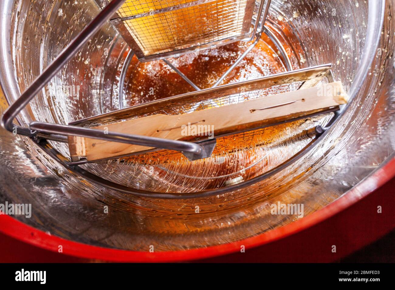 The process of extracting honey from bee honeycombs Stock Photo - Alamy