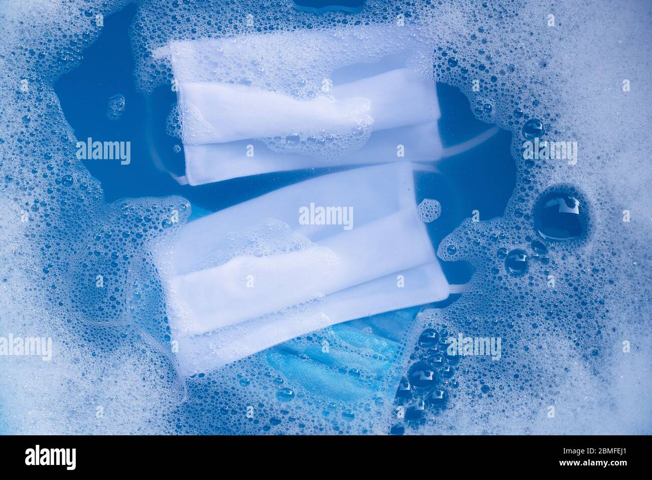 Cloth masks soak in powder detergent water dissolution before washing ...