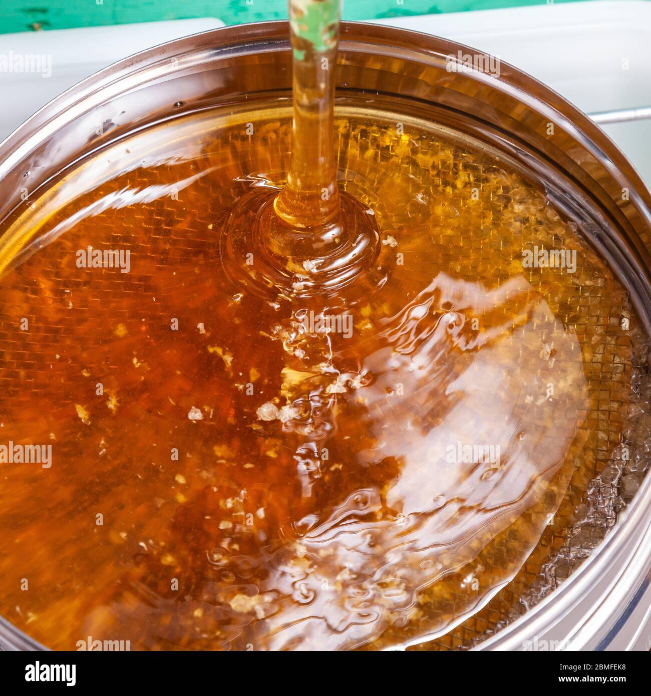 The process of extracting honey from bee honeycombs Stock Photo - Alamy