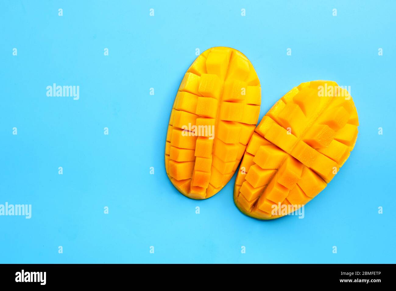 Tropical fruit, Mango on blue background. Copy space Stock Photo - Alamy