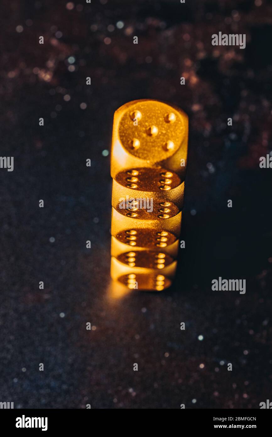 A Stack of golden dice Stock Photo - Alamy