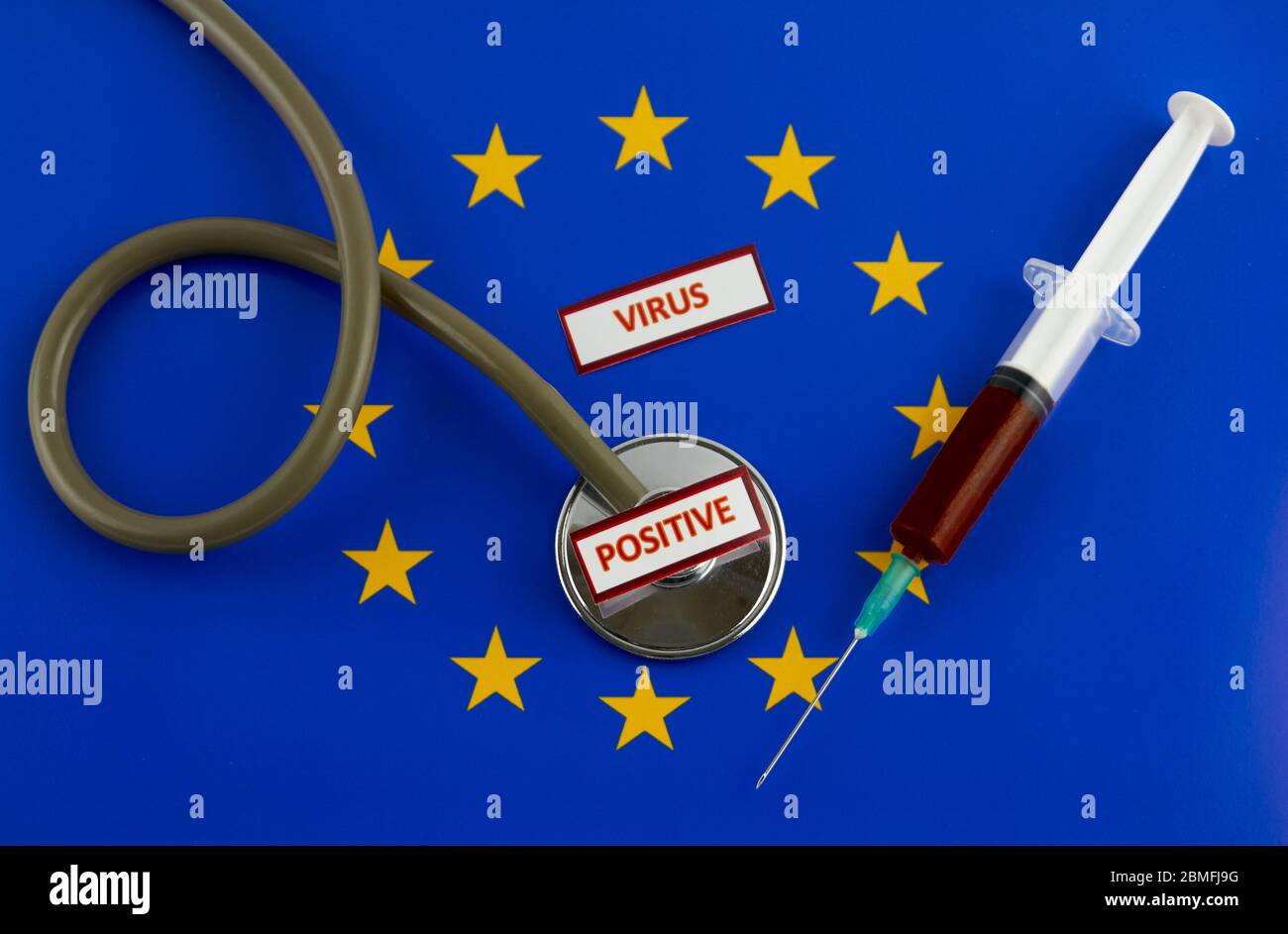 Stethoscope and syringe on EU flag with virus label Stock Photo - Alamy