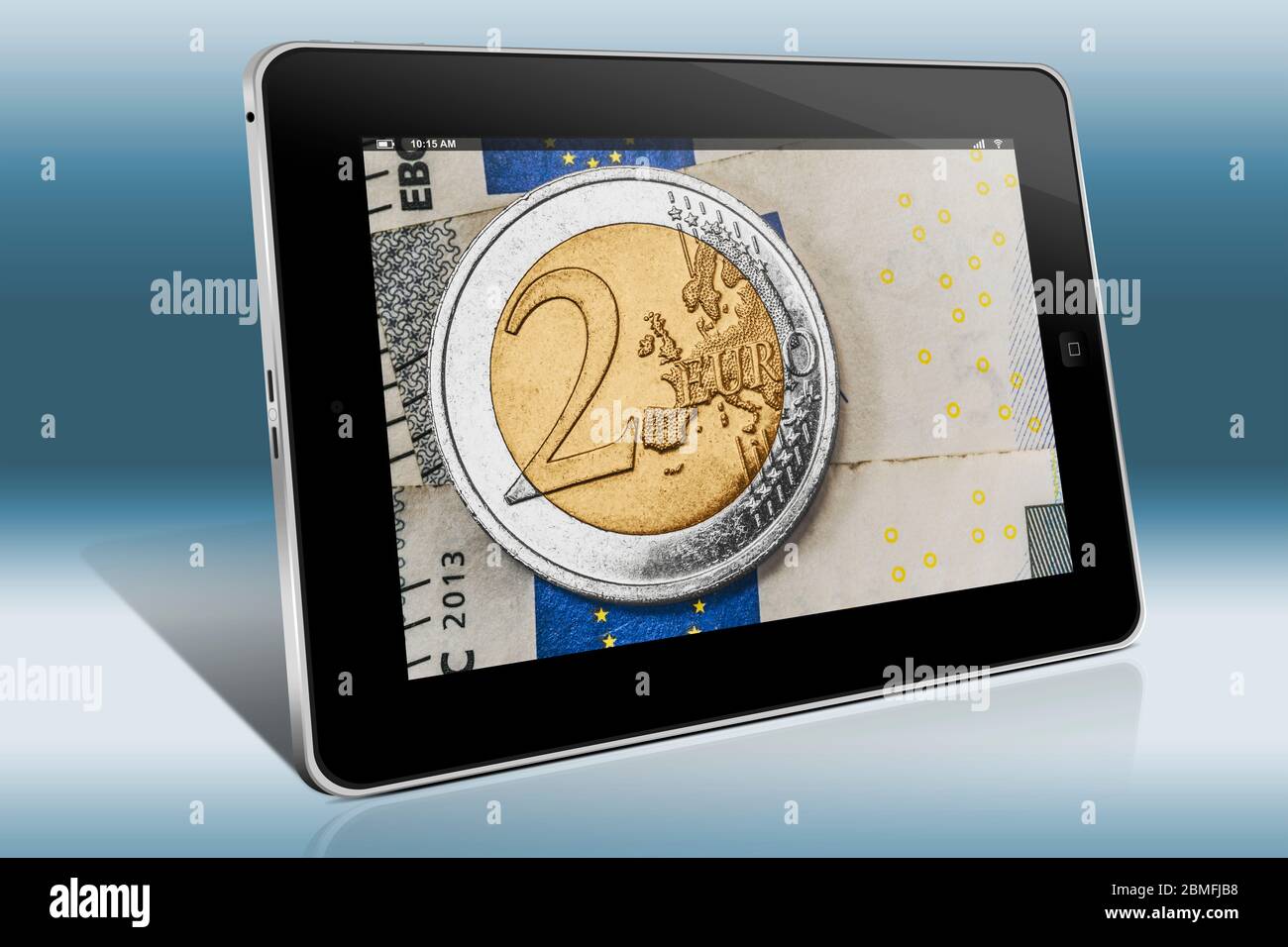 a 2 euro coin on euro banknotes, view on a Tablet PC Stock Photo - Alamy