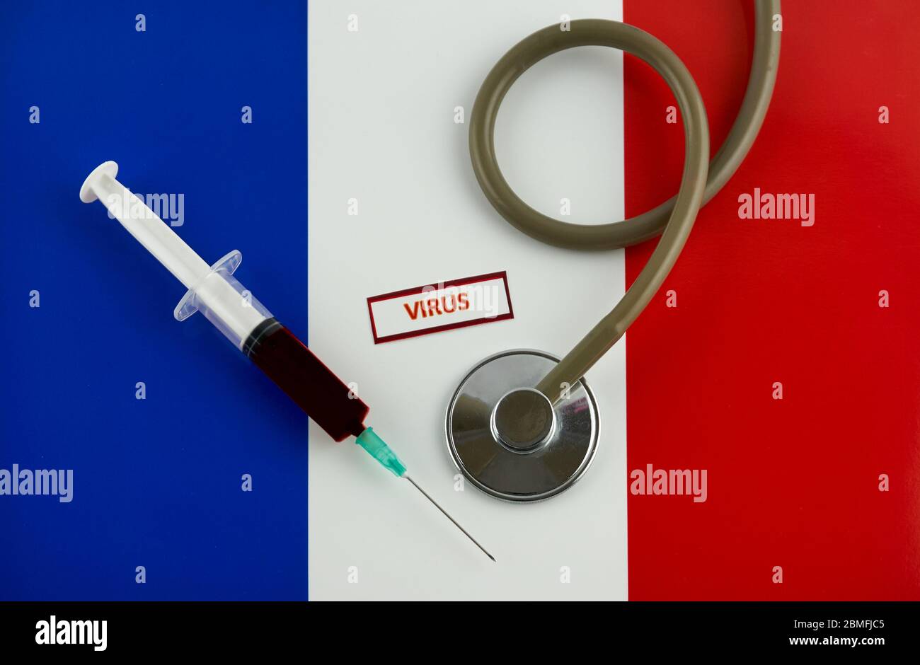 Stethoscope and syringe on France flag with virus label Stock Photo - Alamy