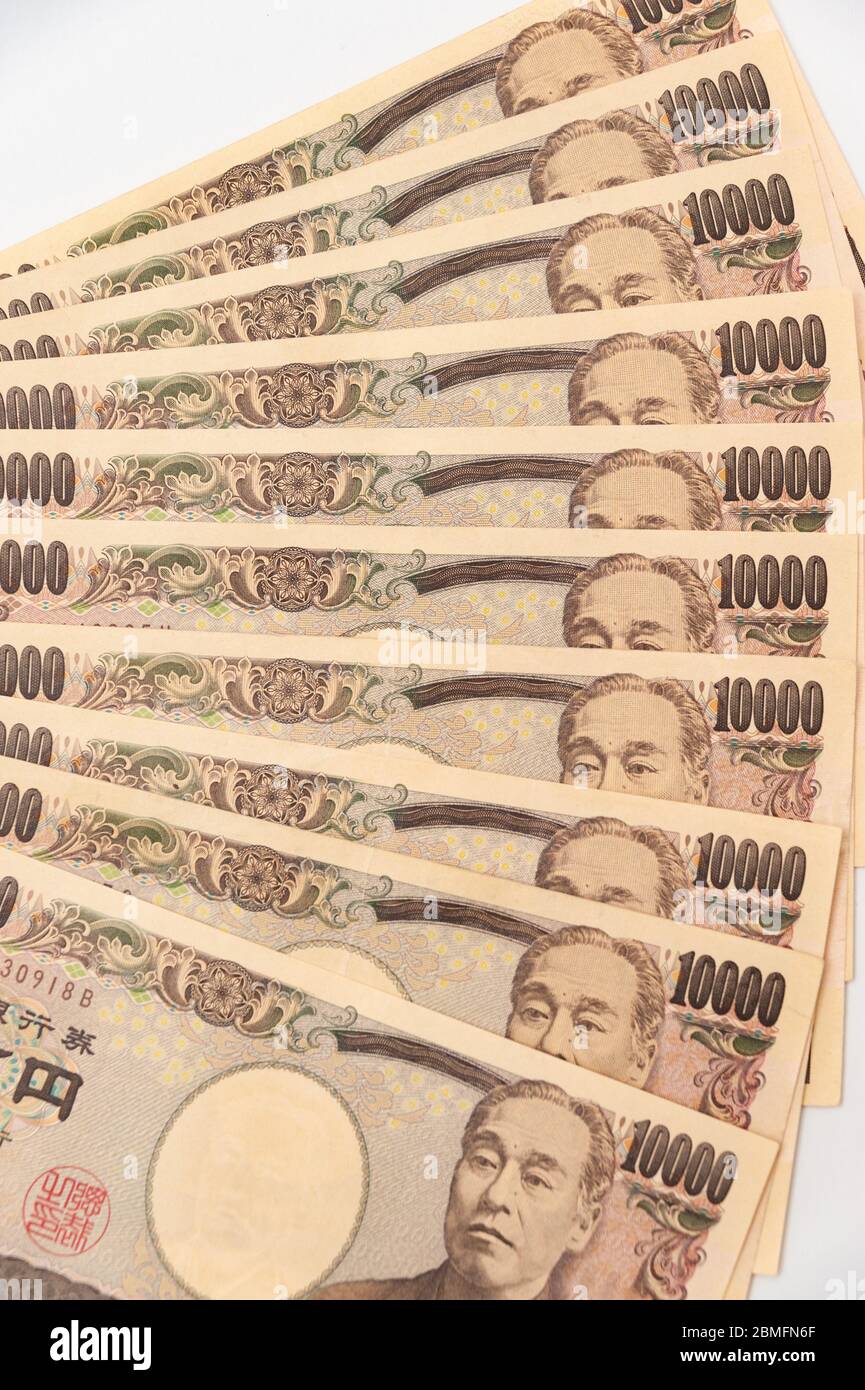 Close-up of 100,000 yen stacked in layers of 10,000 yen banknotes ...