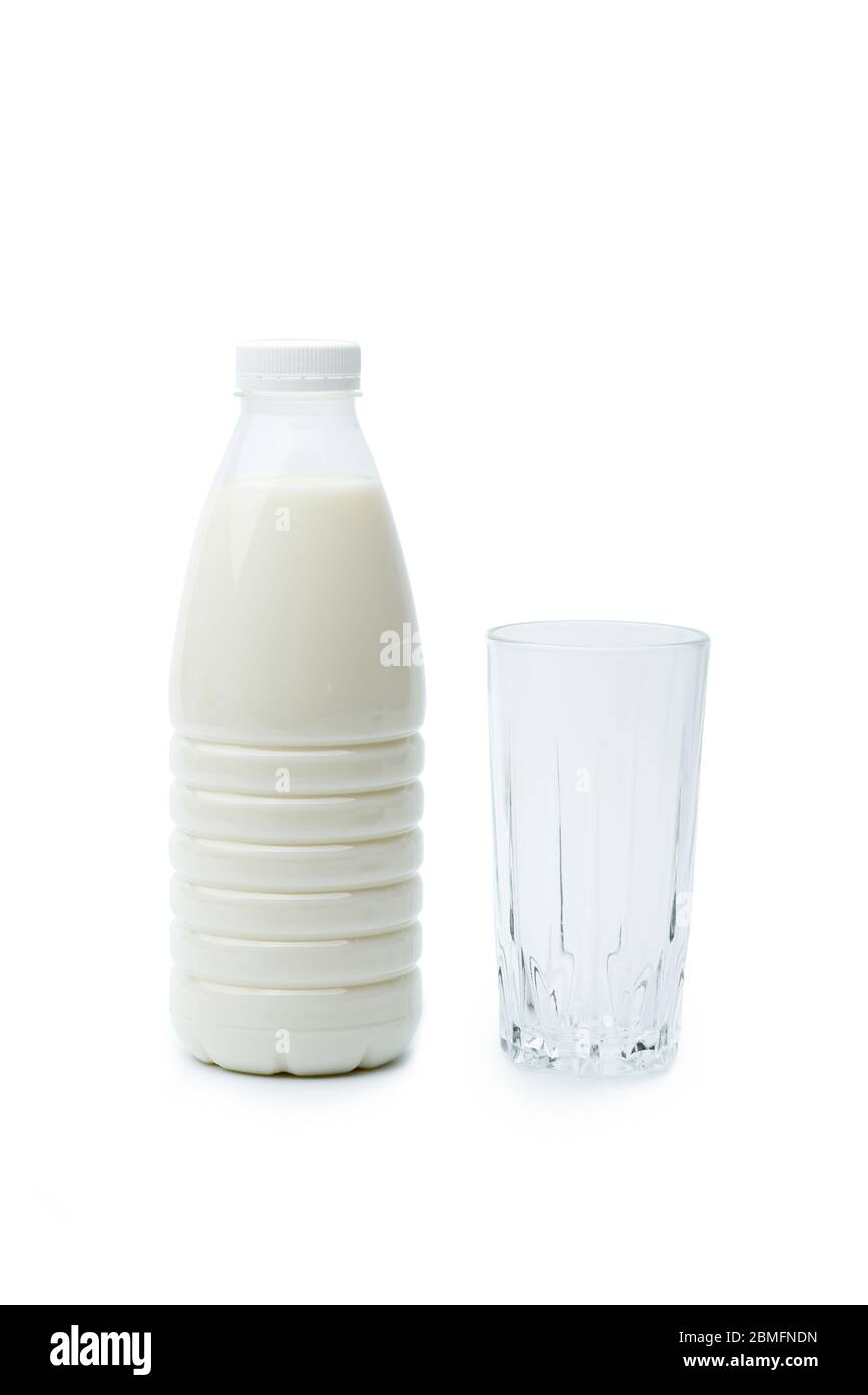 Full plastic bottle of milk and an empty glass isolated on a white ...