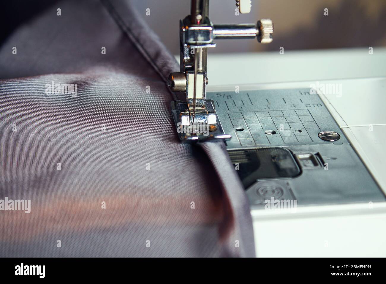 A man hem a curtain on sewing machine. Sewing, hobbies, hobby, home ...