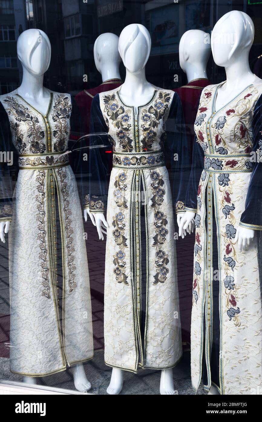 Traditional Turkish dress long sleeved, behind glass in a street shop ...