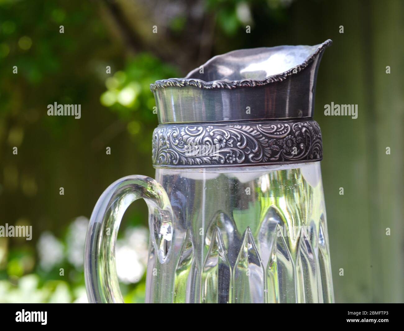 Glass and silver pitcher Stock Photo - Alamy