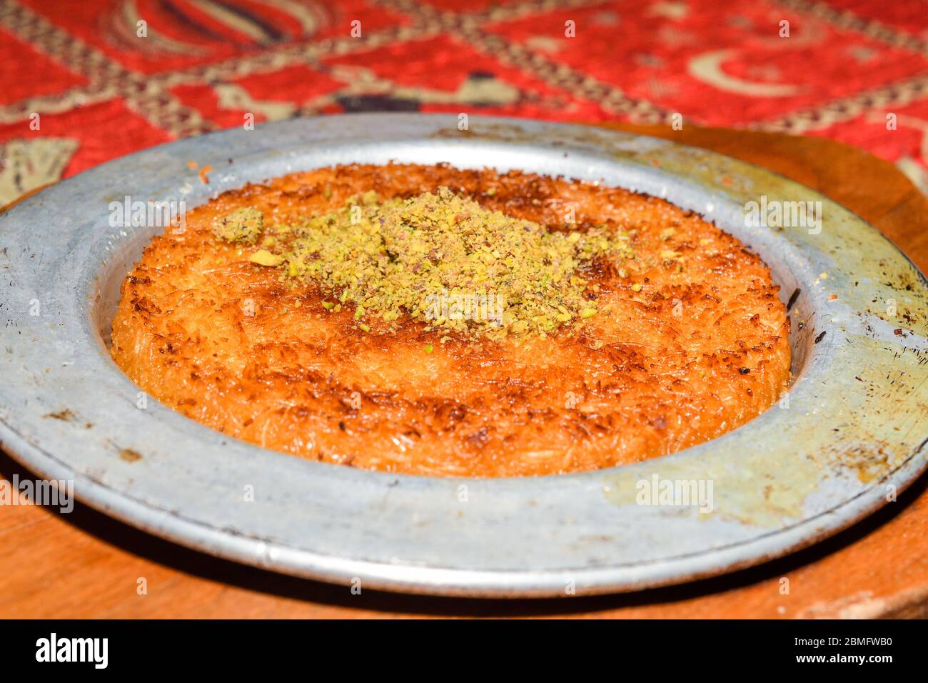 Turkish dessert kunefe with pistachio powder. Kunafa, kadayif with ...