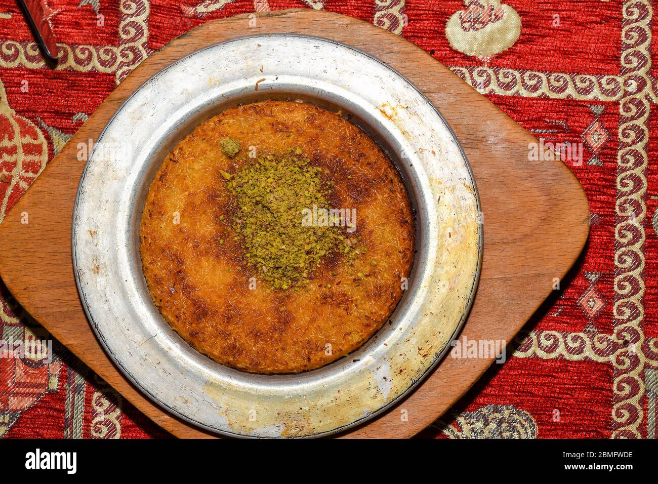 Turkish dessert kunefe with pistachio powder. Kunafa, kadayif with ...