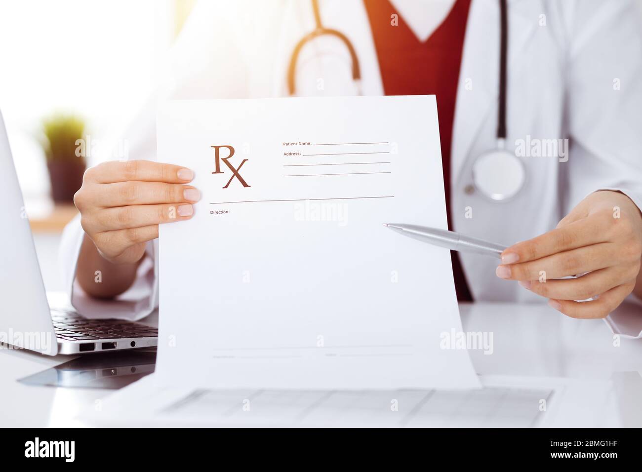 Unknown woman-doctor pointing into empty prescription form record close ...