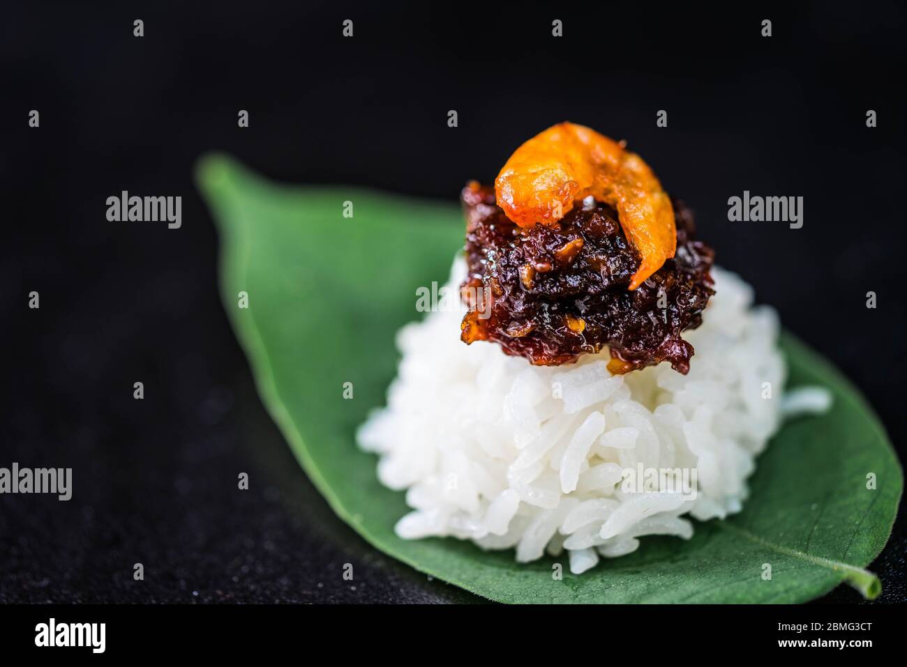 Spicy chili paste with steamed rice on dark background Stock Photo - Alamy