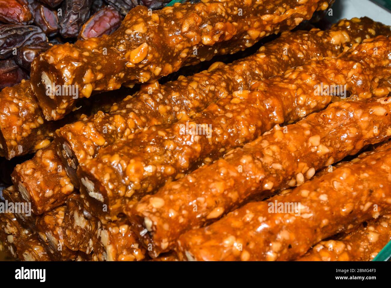 Cevizli sucuk made by dipping a string with walnuts into a grape ...