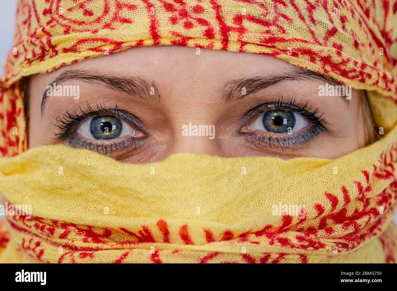 Female eyes, yellow burqa face in patterns Stock Photo - Alamy