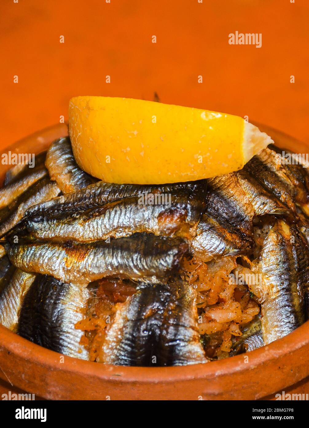 Marinated fresh sardines in a bowl with lemon Stock Photo - Alamy