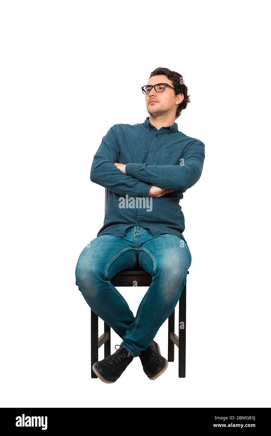 Full length portrait of confident businessman seated relaxed on a chair ...
