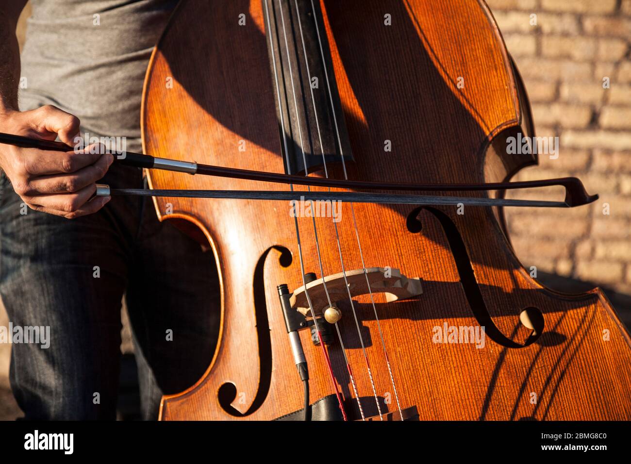 Man in black playing cello hi-res stock photography and images - Alamy