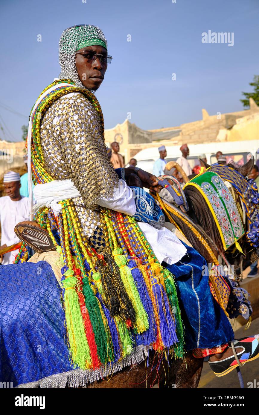 Nobleman rider dressed in a colourful outfit mounting an embellished ...
