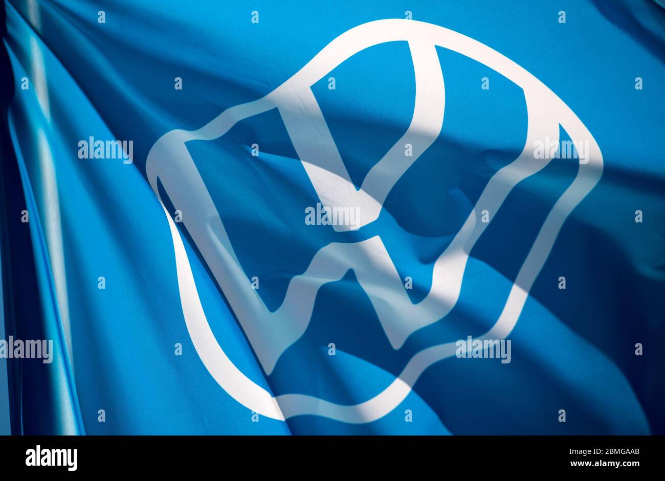 23 April 2020, Saxony, Zwickau: Flags with the VW logo are waving in ...