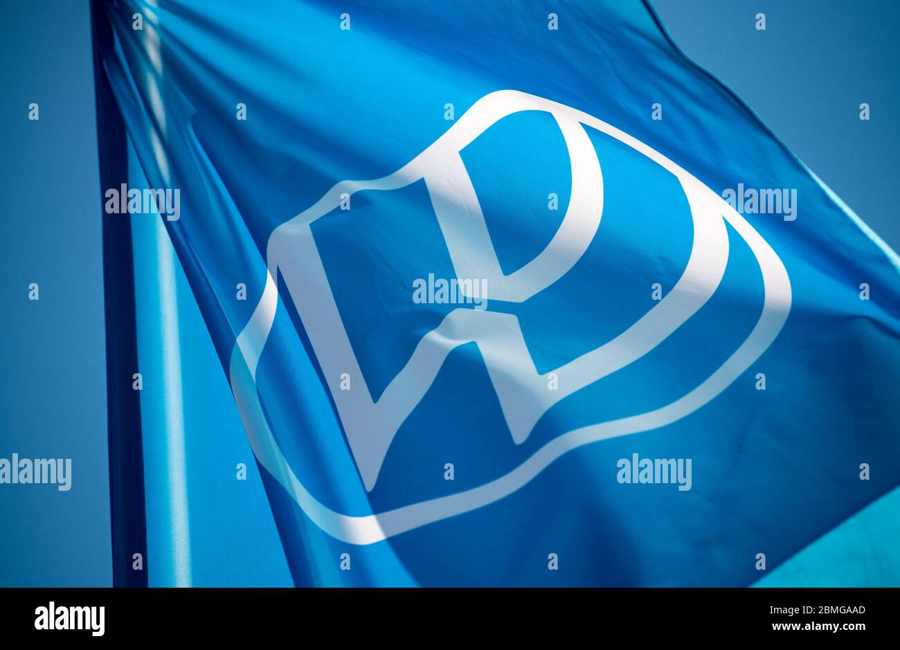 23 April 2020, Saxony, Zwickau: Flags with the VW logo are waving in ...