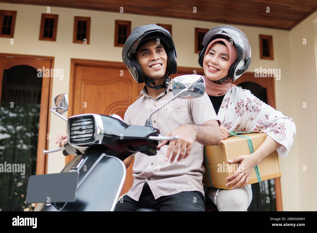 Muslim woman riding a scooter hi-res stock photography and images - Alamy