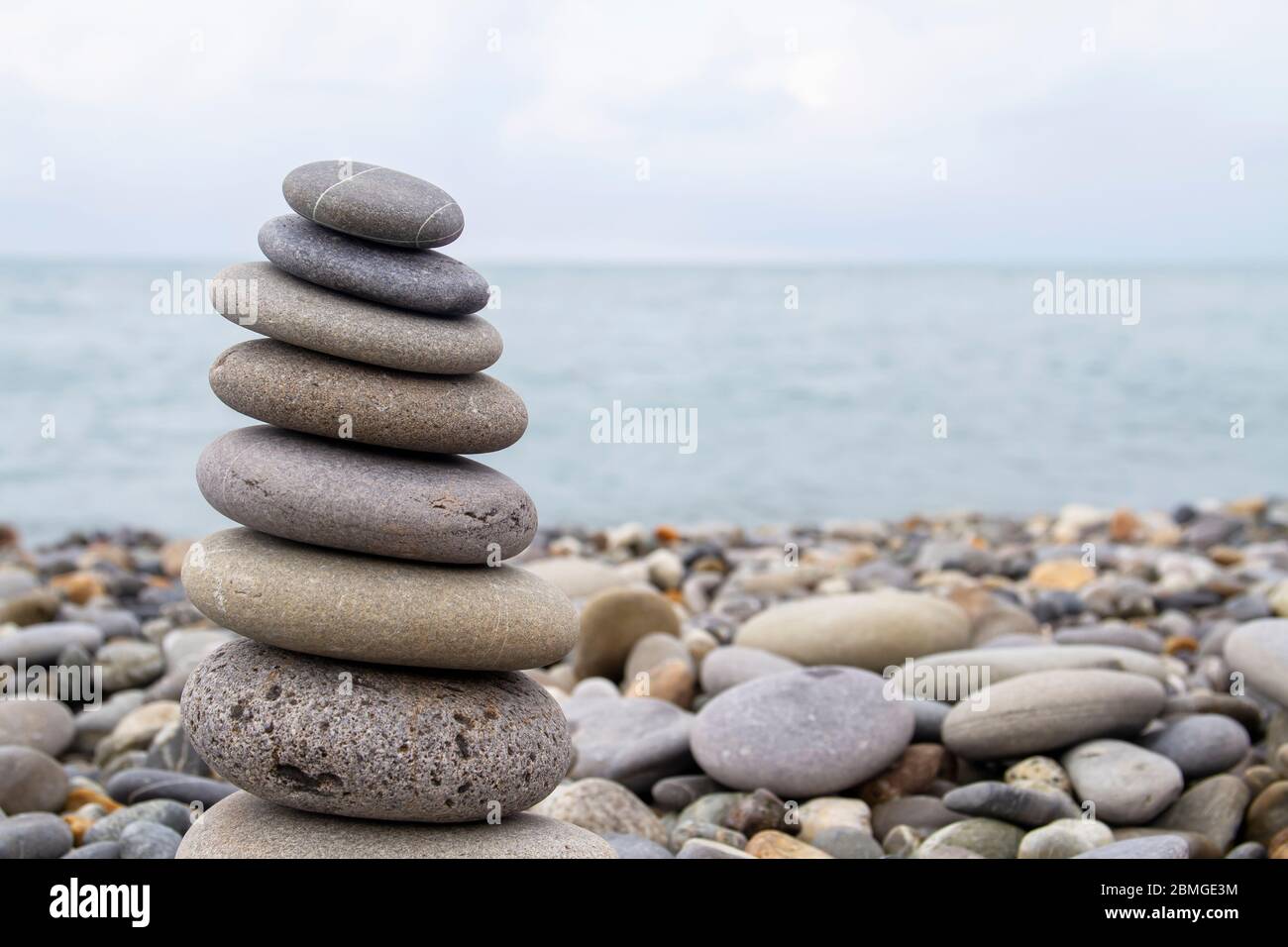 Pyramid of sea stones on the seashore at the pebble beach. Concept of ...