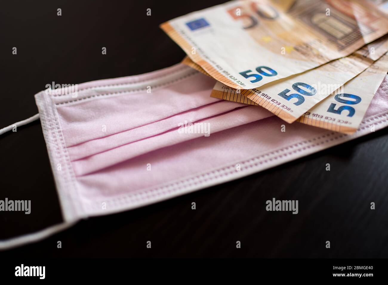 Medical face masks and money. Surgical face mask. COVID-19 Has Caused A ...