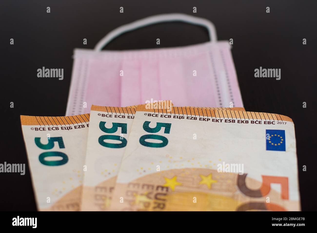 Medical face masks and money. Surgical face mask. COVID-19 Has Caused A ...