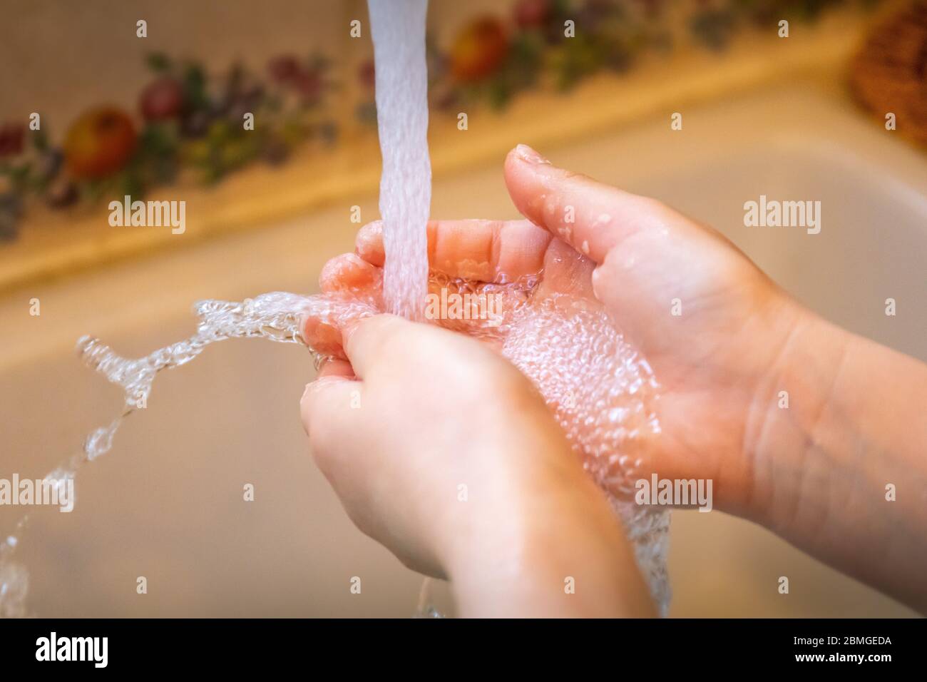 splashing running water whilst washing hands to keep them clean and ...
