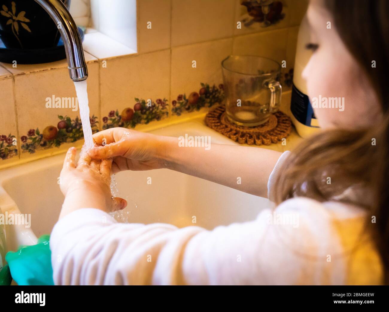washing hands to keep them clean and free from germs in the kitchen ...