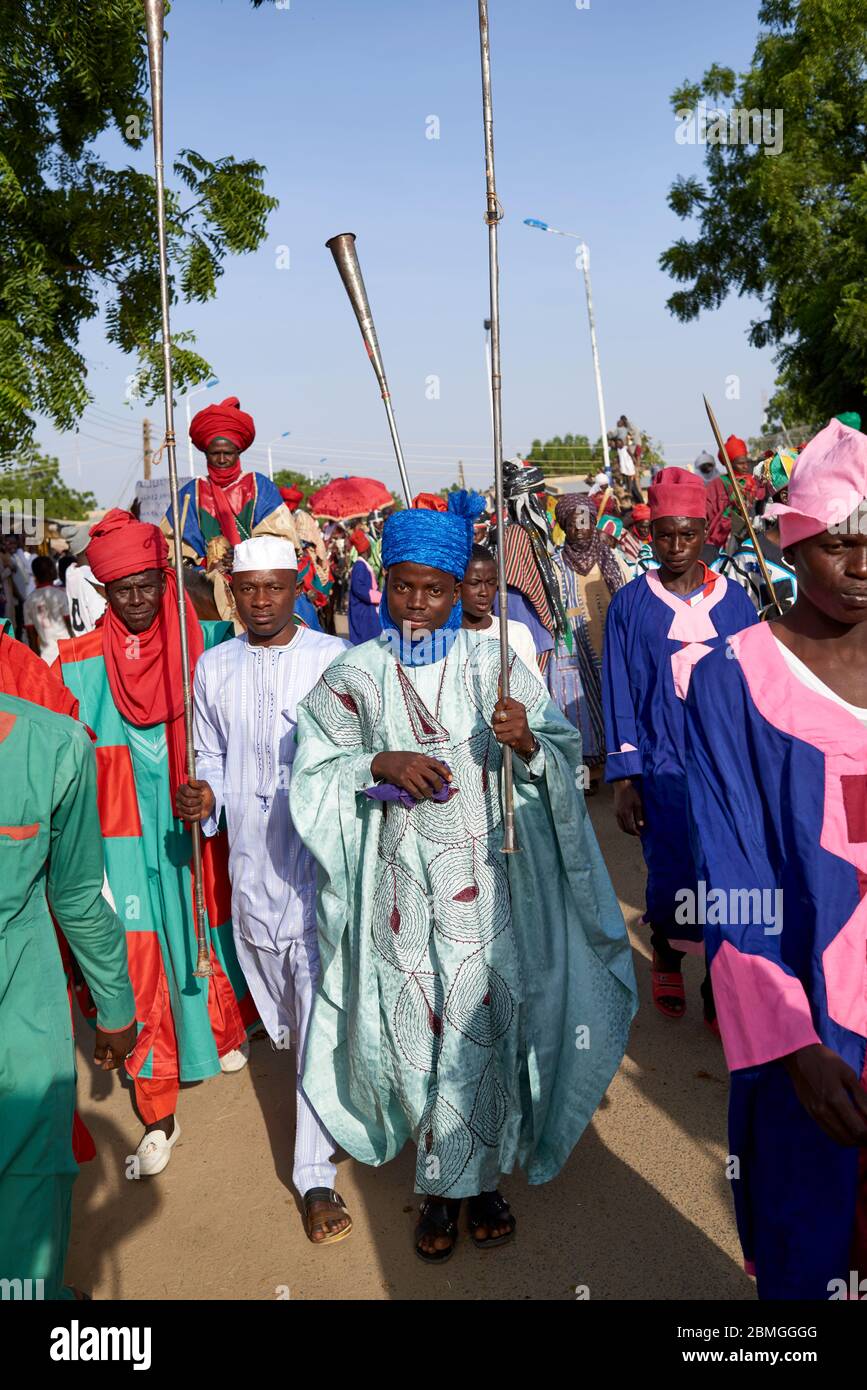 Musicians carrying traditional Nigerian trumpets during the celebration ...