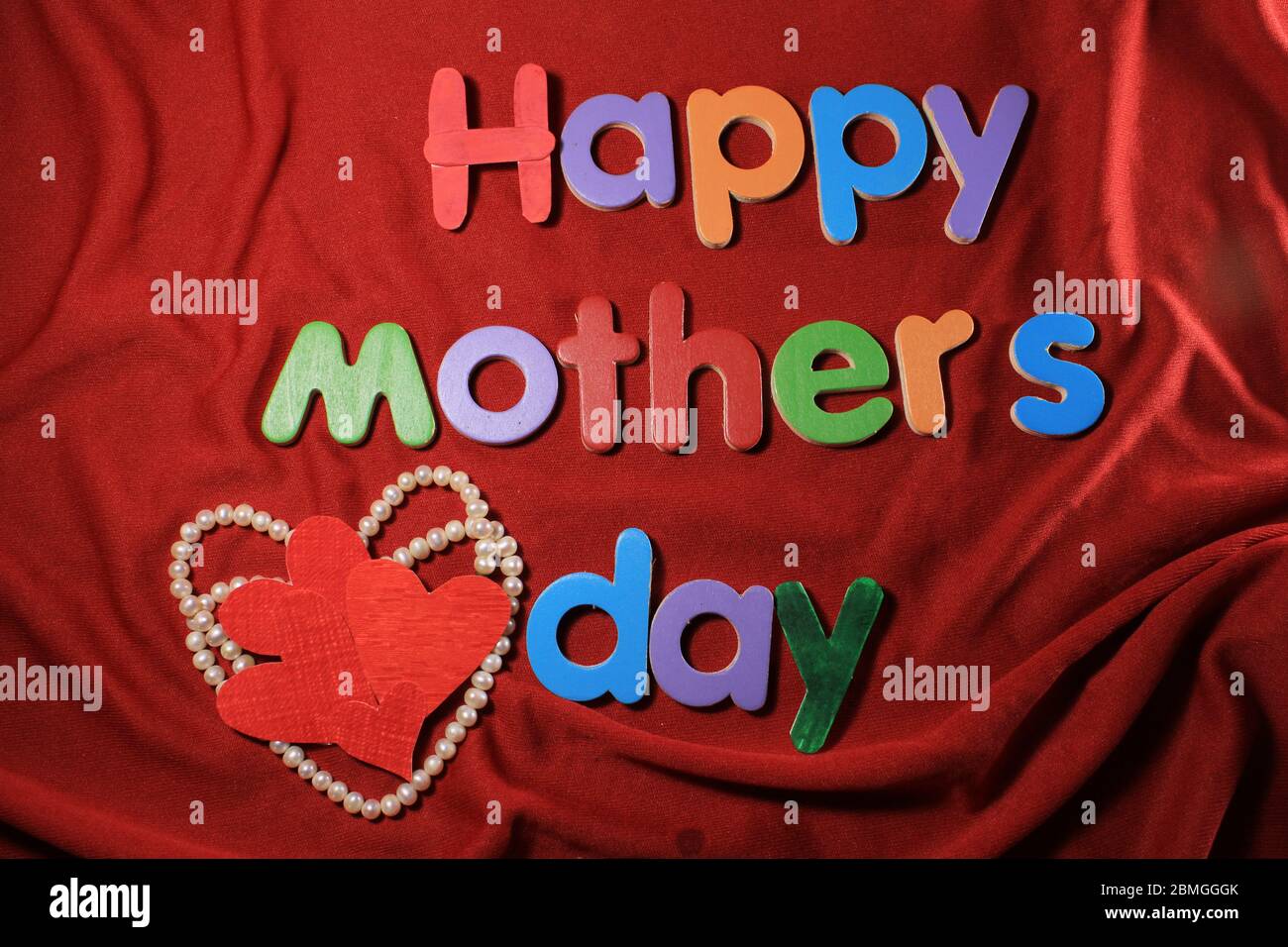 Happy Mother's Day written on red cloth texture background. Happy ...