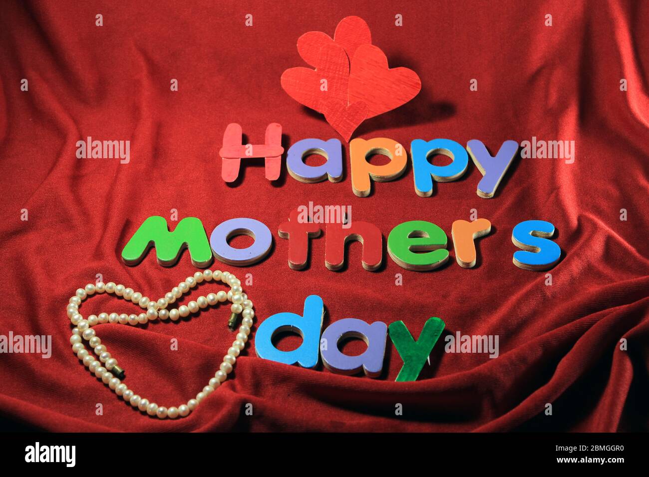 Happy Mother's Day written on red cloth texture background. Happy ...
