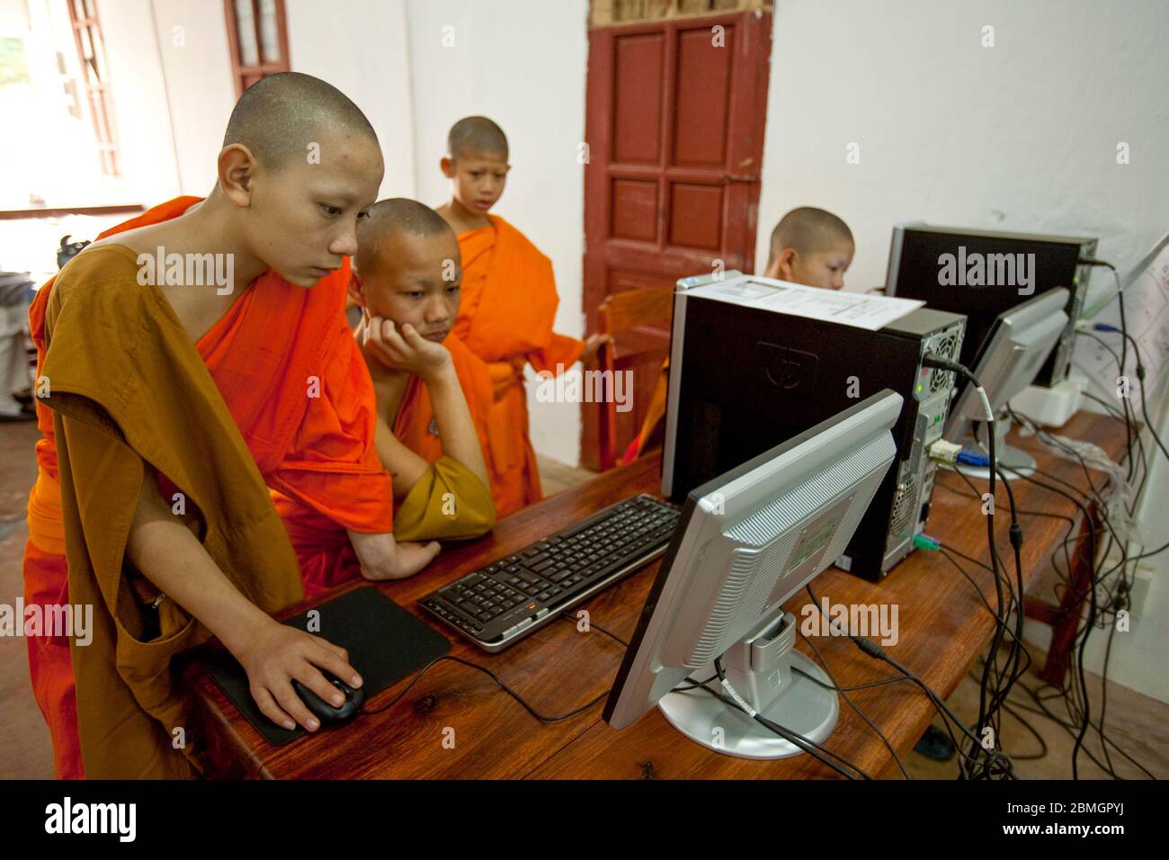 YOUNG BUDDHISTS MONKS USING COMPUTERS IN LUANG PRABANG, LAOS Stock ...