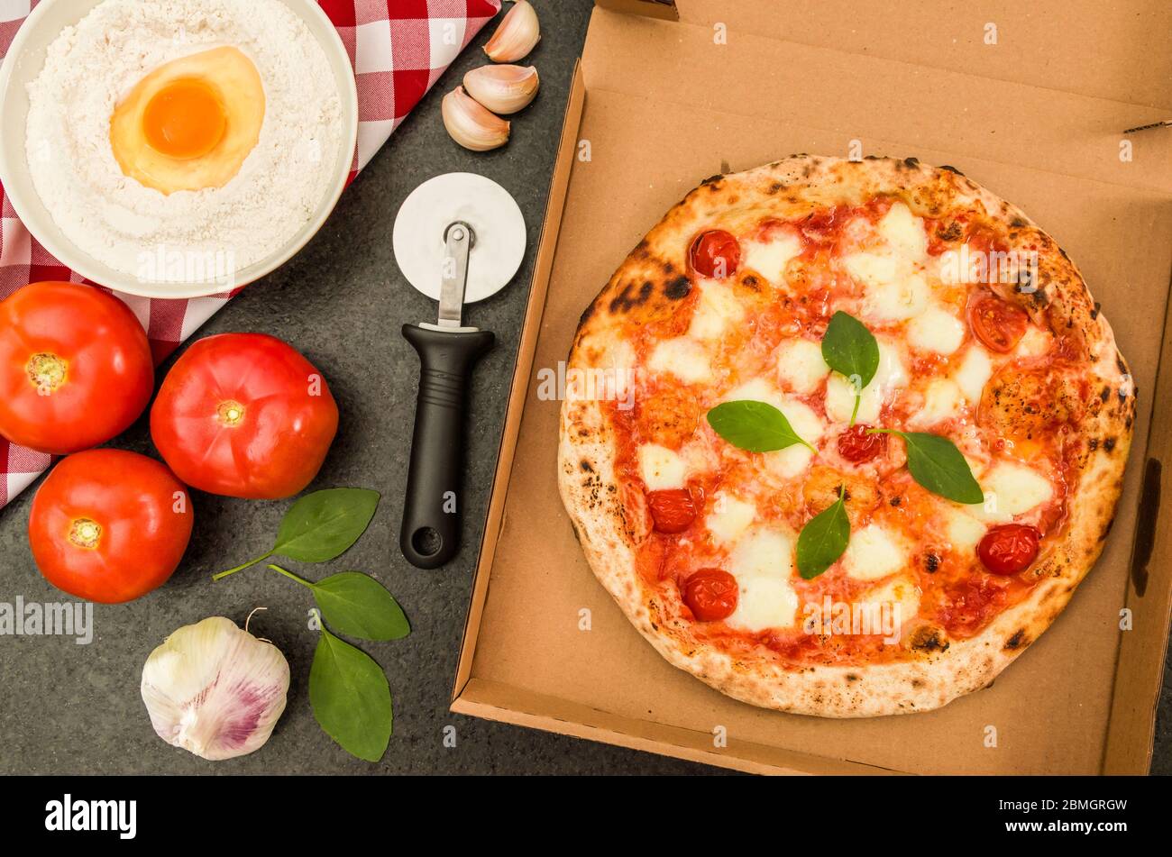 Great background for culinary themes, pizza inside the box on a black ...