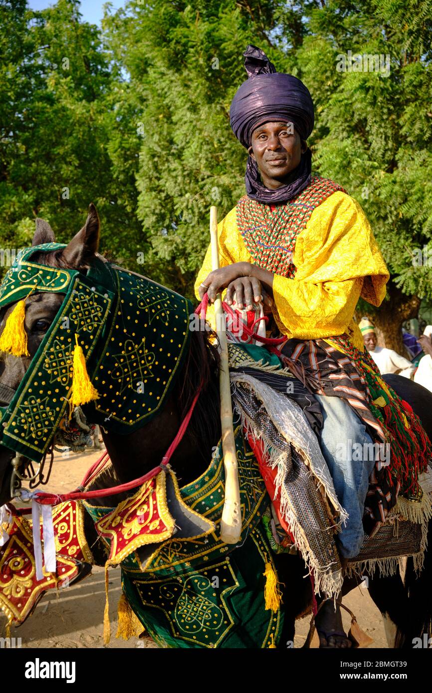 Nobleman rider dressed in a colourful outfit mounting an embellished ...
