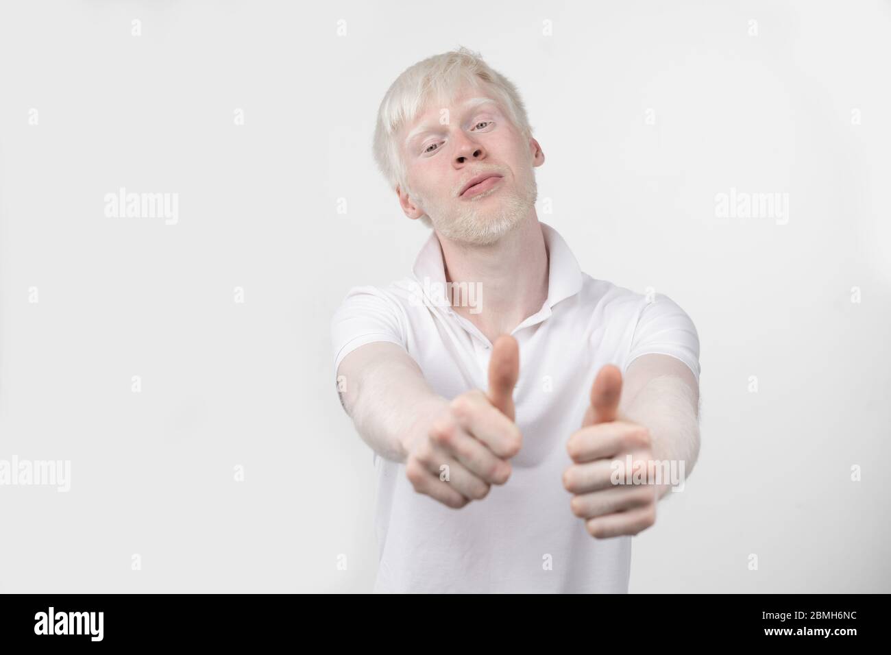 portrait of an albino man in studio dressed t-shirt isolated on a white ...