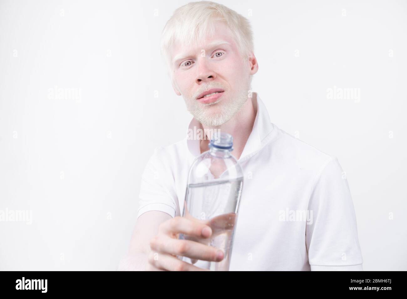 portrait of an albino man in studio dressed t-shirt isolated on a white ...
