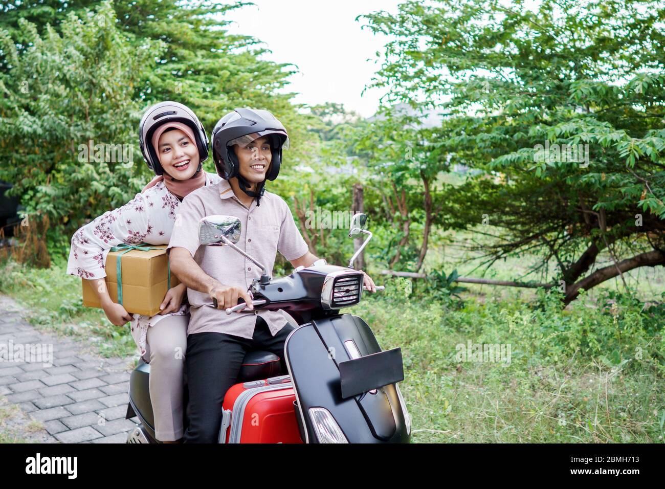Muslim woman riding a scooter hi-res stock photography and images - Alamy