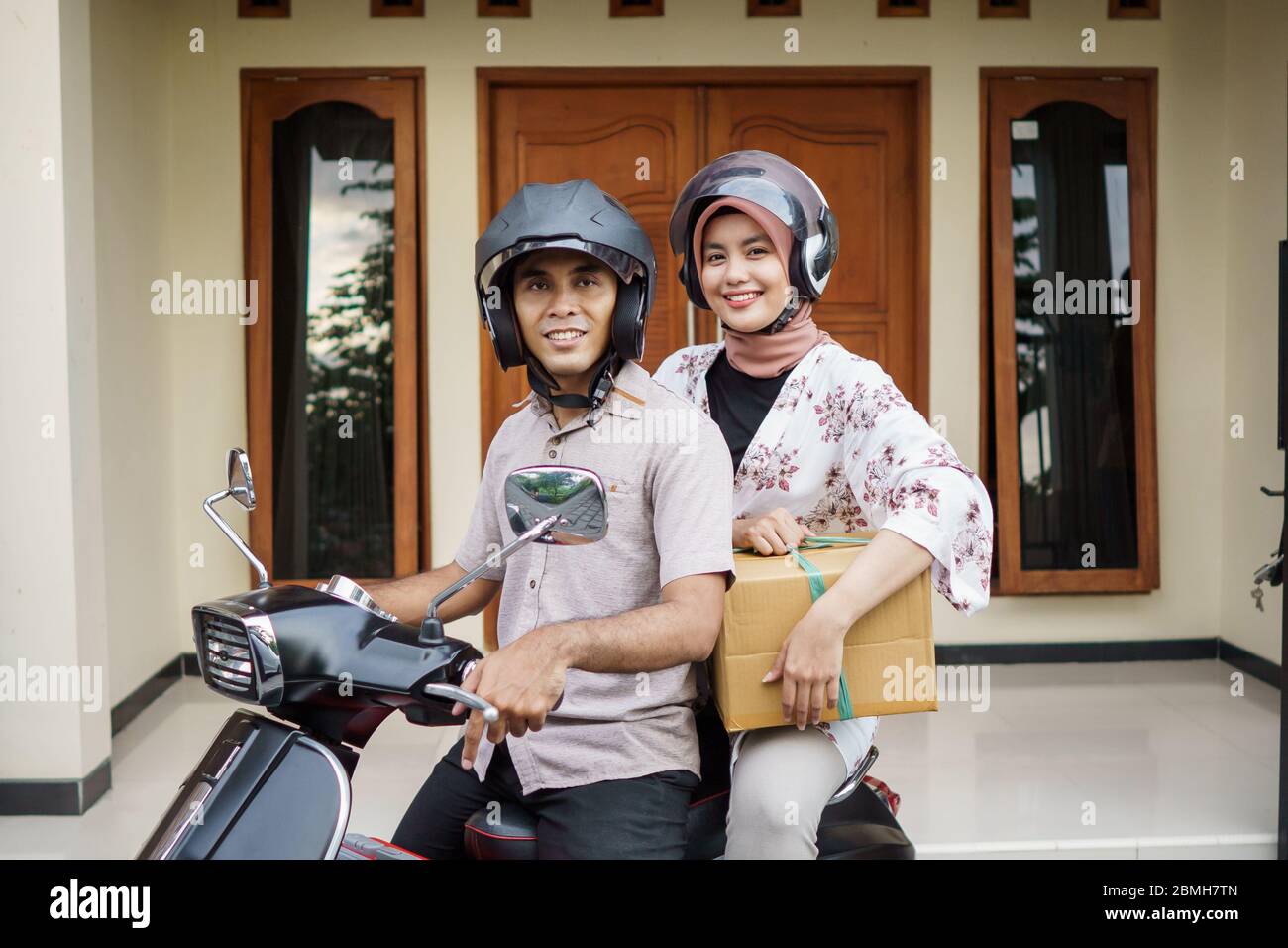 Muslim woman riding a scooter hi-res stock photography and images - Alamy